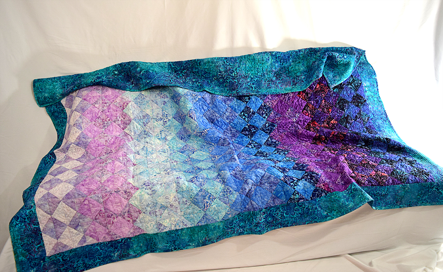 soothing batik half square triangles quilt